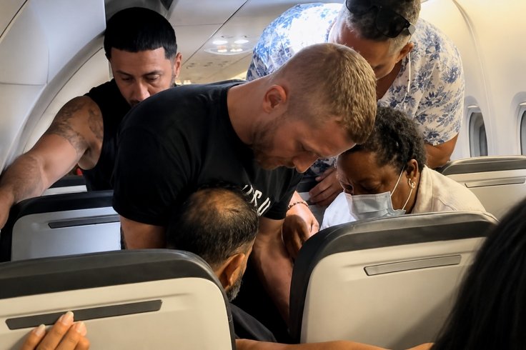 Frontier Airlines Passenger Accused of Trying to Open Exit Door, Force ...